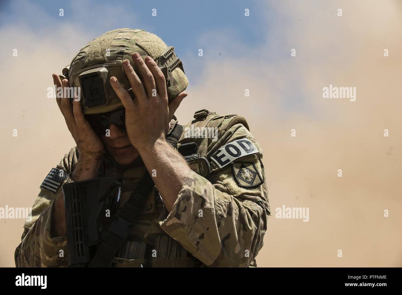 Airman 1st Class Jared Ball, EOD team member, shields his face from ...