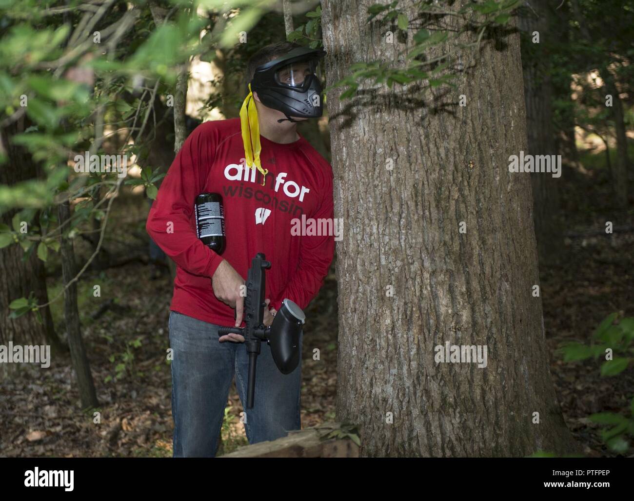 An attendee takes cover during the Quantico Paintball Park grand ...