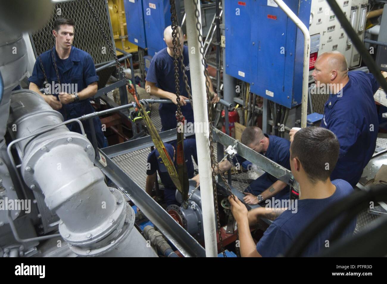 Coast Guard engineers make repairs to the main engine of the Coast ...