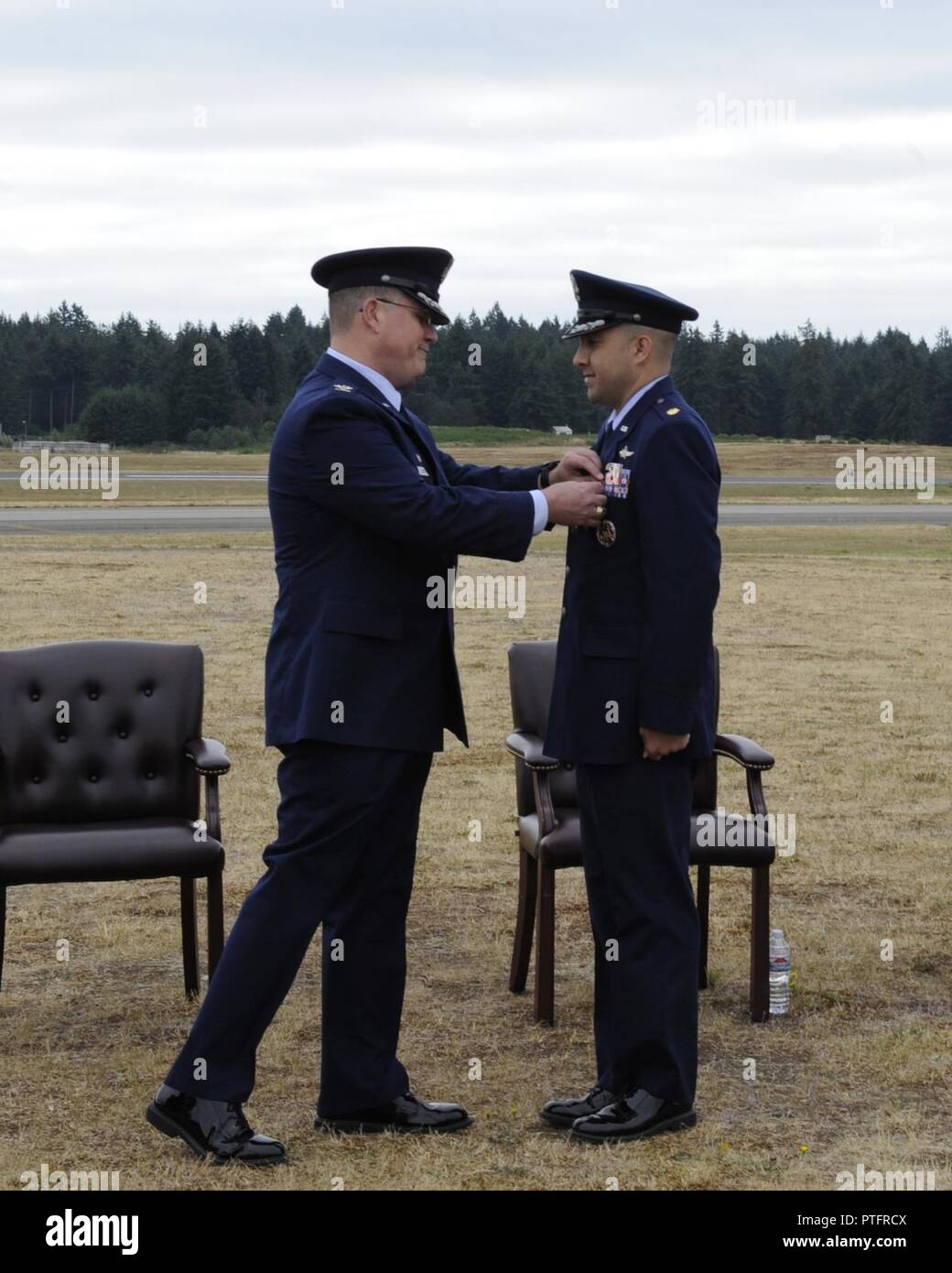 Colonel William D. Precival the Deputy Joint Base Commander pinning the ...