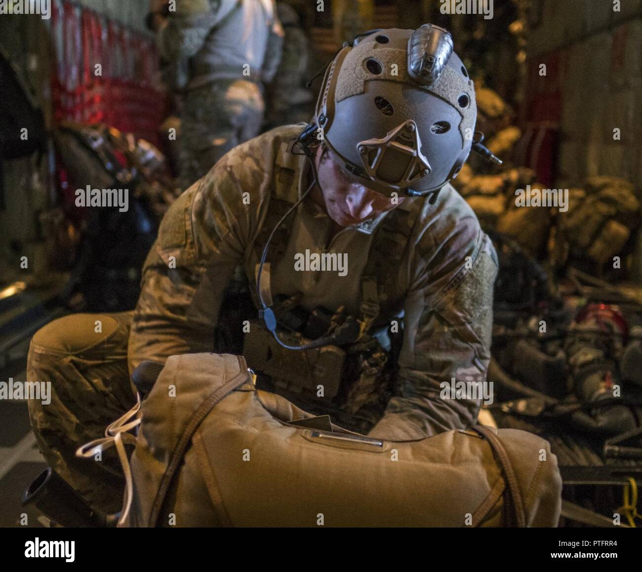 A U.S. Air Force 320th Special Tactics Squadron pararesuceman inspects ...
