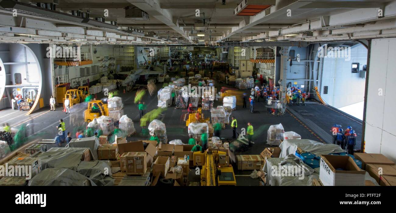 CORAL SEA (July 15, 2017) Sailors move cargo throughout the hangar bays ...