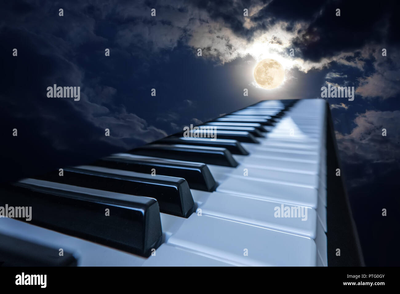 piano keys in moonlight cloudy night Stock Photo - Alamy