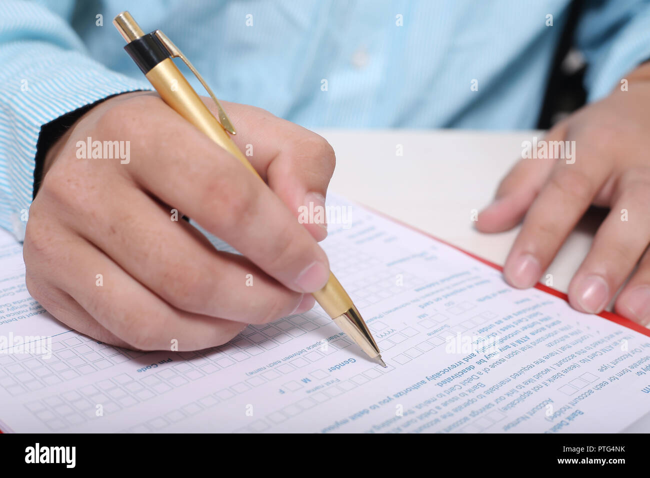 Picture of man hand is filling form with pen Stock Photo - Alamy