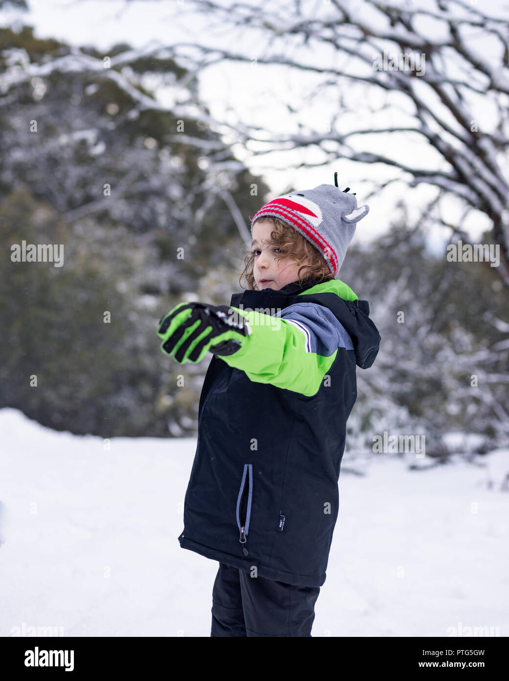 Child throwing snowball hi-res stock photography and images - Alamy