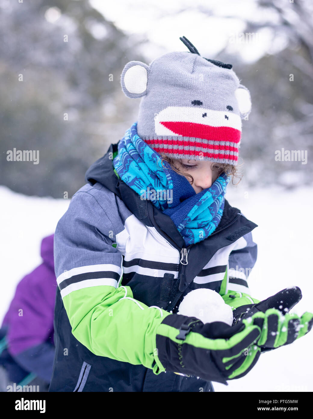 a young boy catches a snowball Stock Photo - Alamy