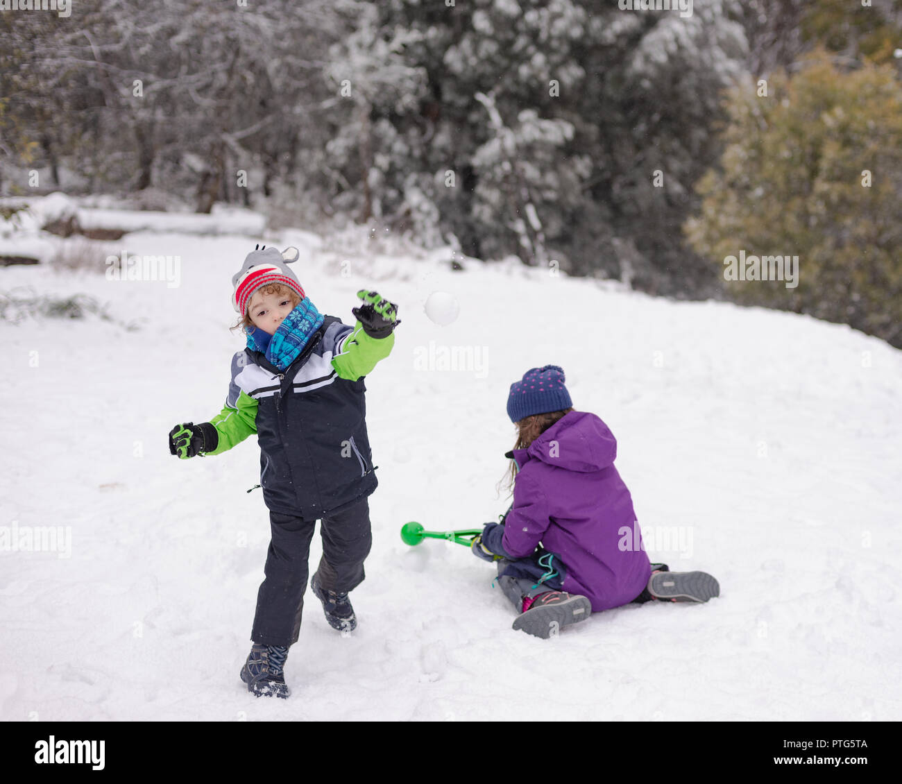 Children throwing snowballs hi-res stock photography and images - Alamy