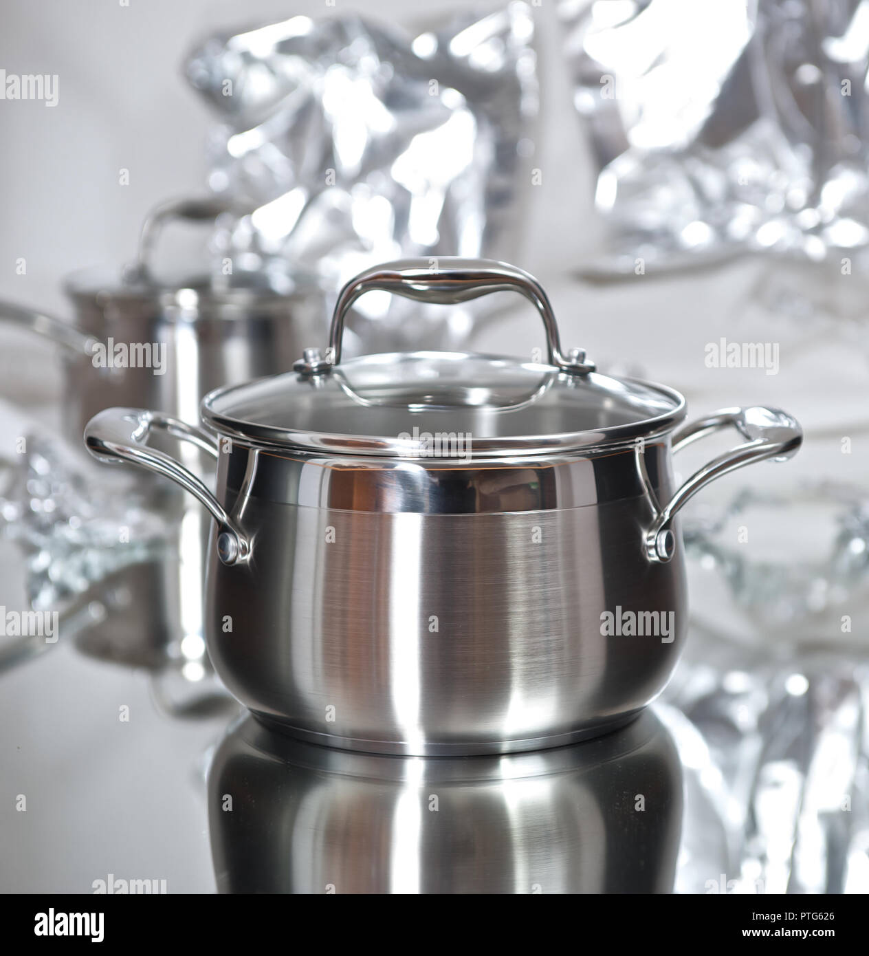 Metal pans on a light shiny background Stock Photo - Alamy