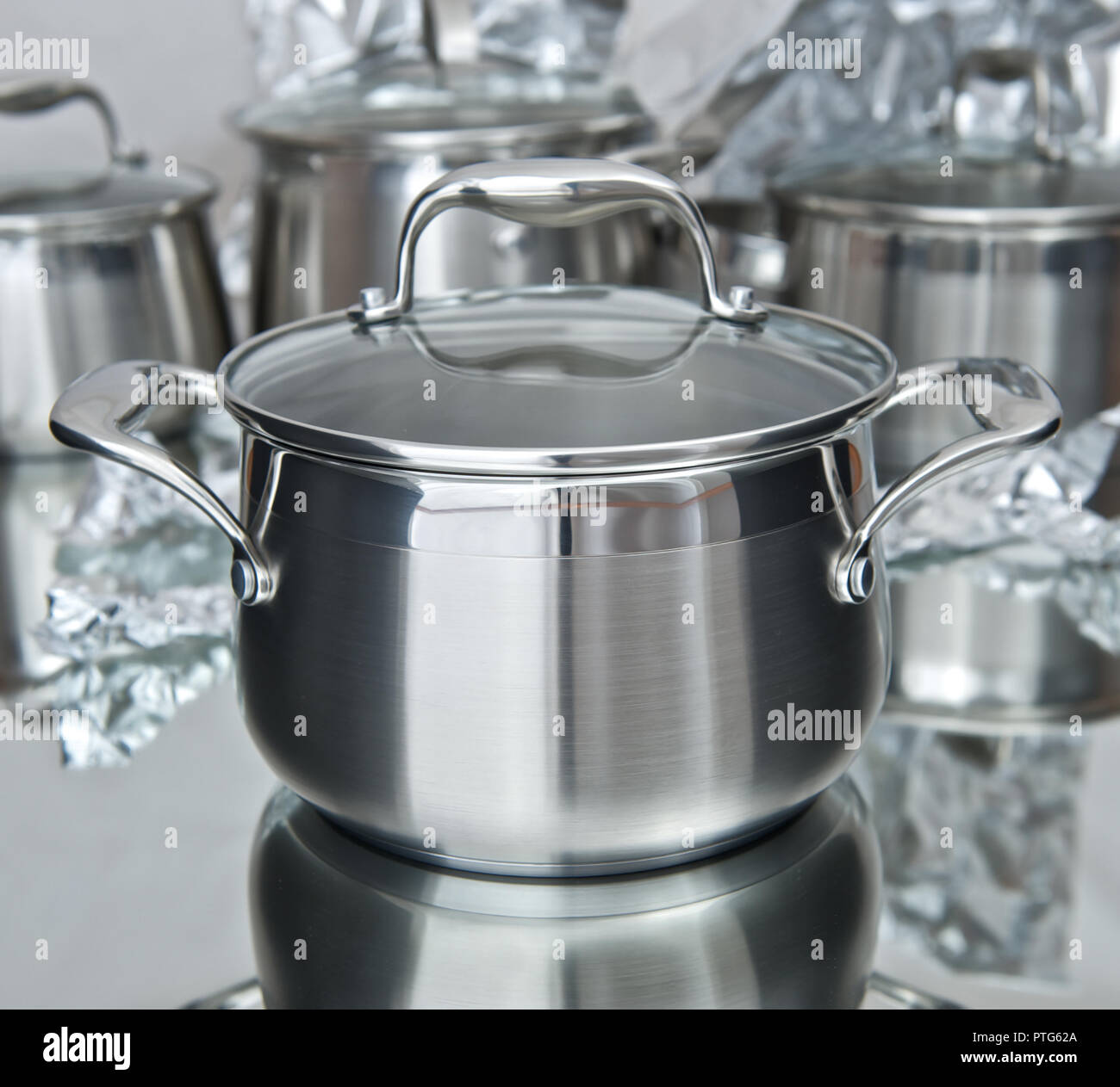 Metal pans on a light shiny background Stock Photo - Alamy