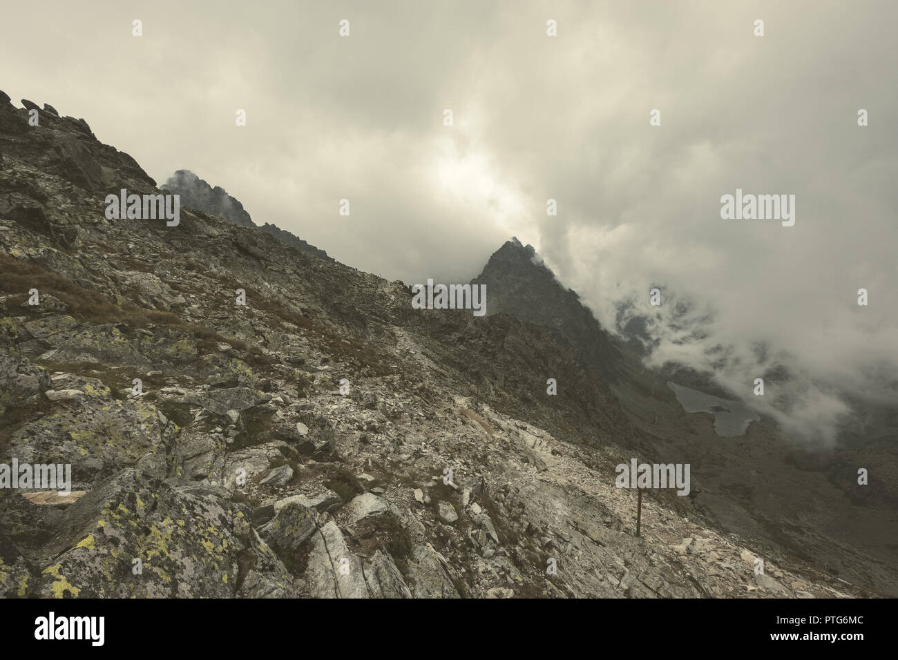 rocky sharp mountain tops in Tatra mountains in Slovakia with clouds ...