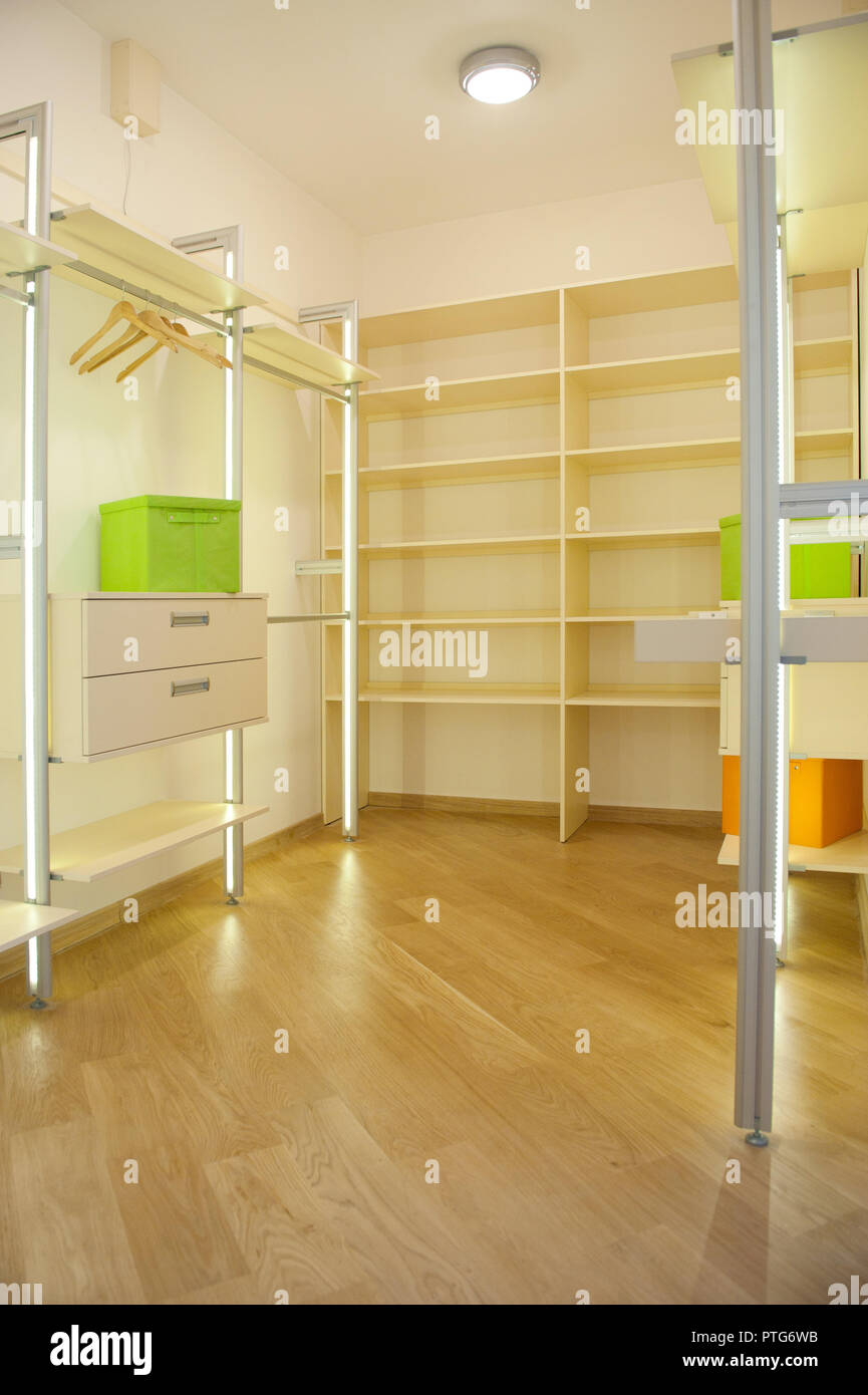 Empty wardrobe room with shelves and cupboards Stock Photo - Alamy