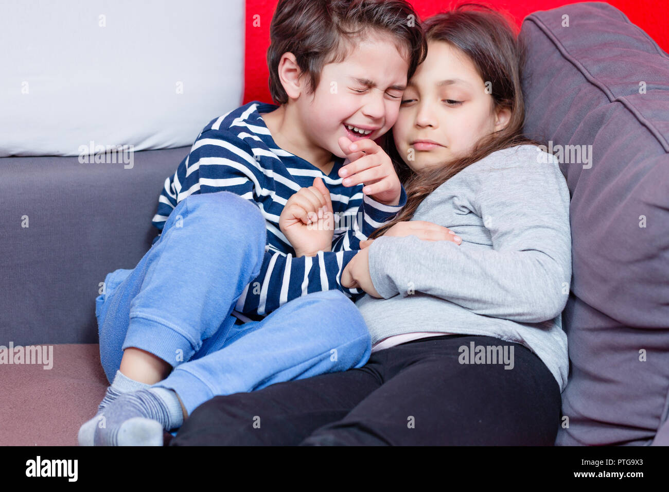 Smiling mischievous boy playing with her sister Stock Photo - Alamy