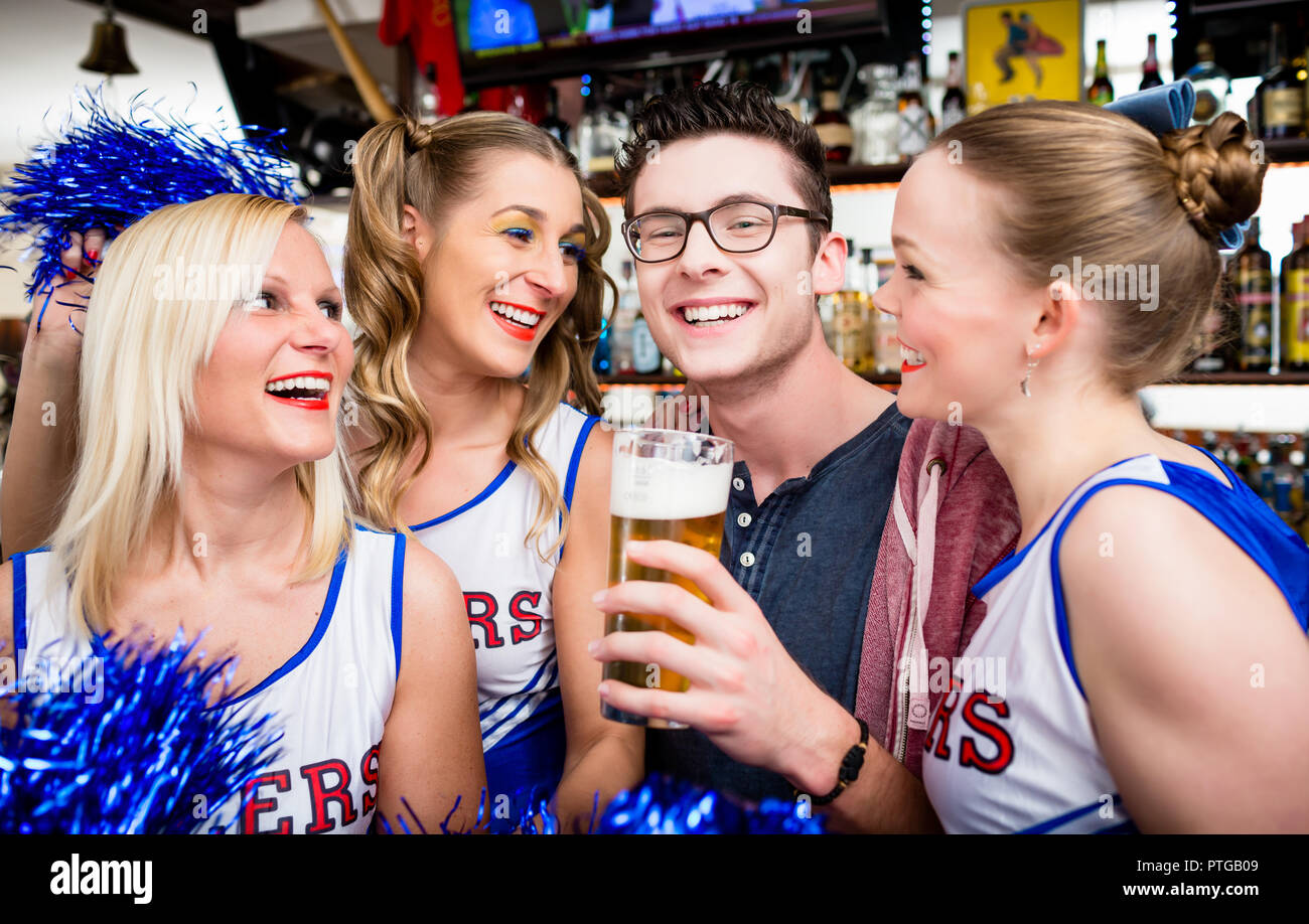 Fans of a sports team watching game in bar drinking beer Stock Photo ...