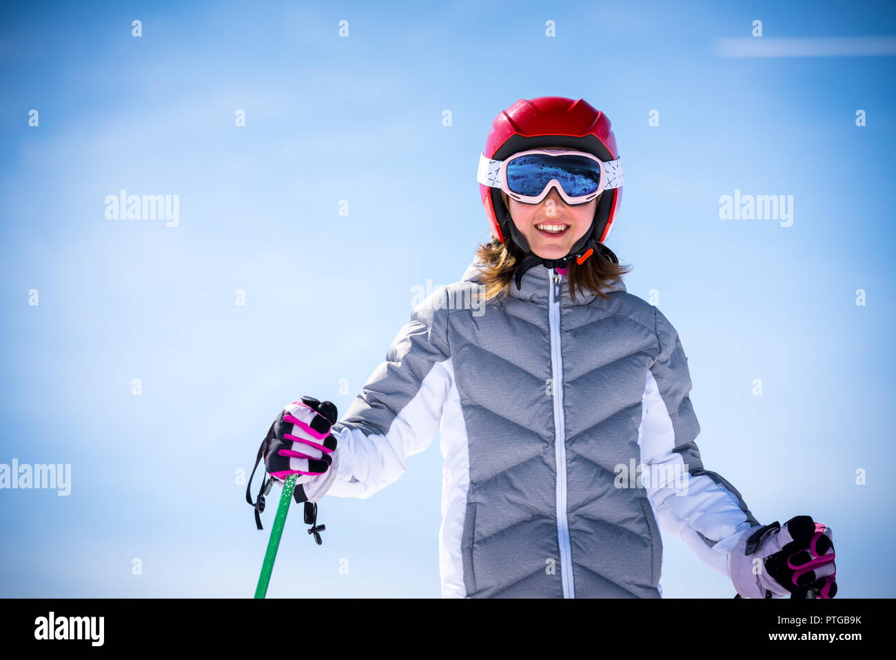 Happy little girl on the ski slopes playing with snow Stock Photo - Alamy