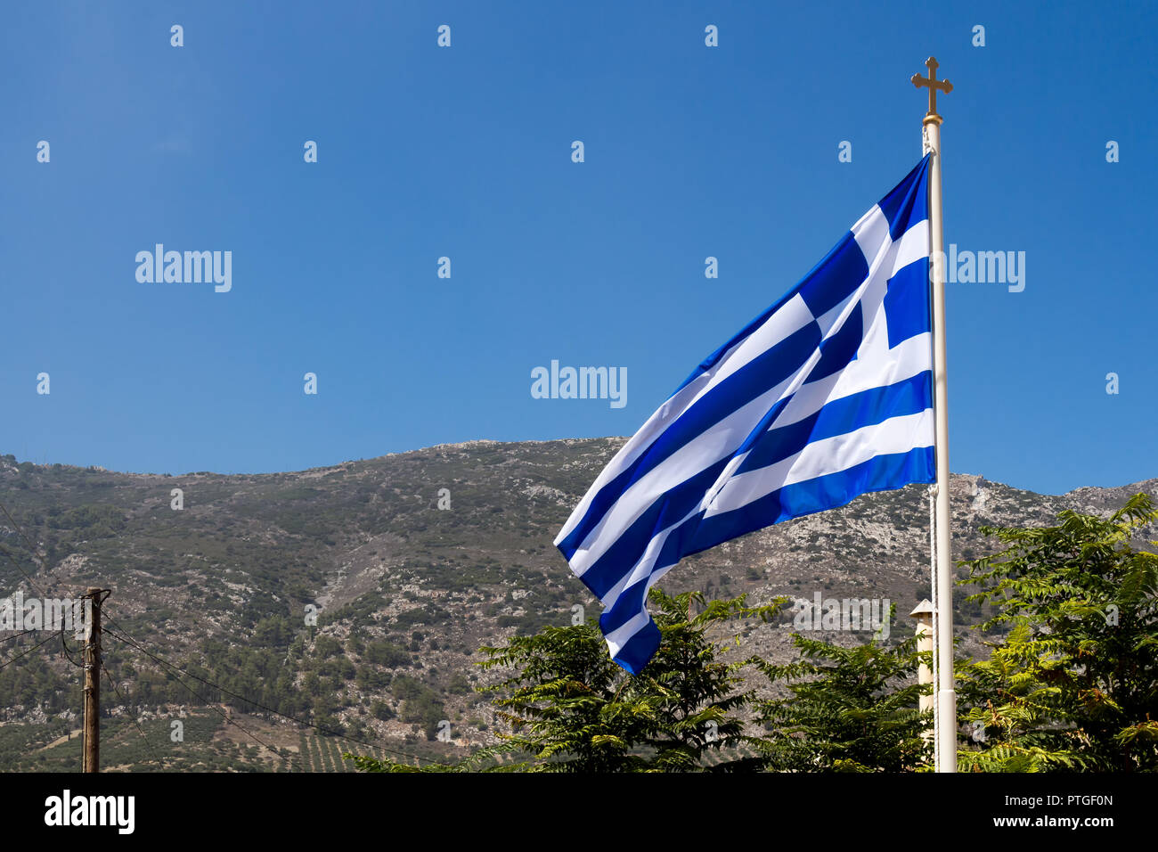 Greek flag blowing in the wind. Traditional cross at the end of the ...