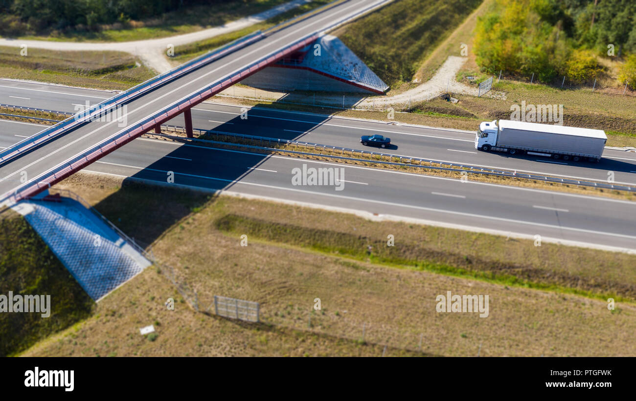 View from above on riding truck on highway under bridge Stock Photo - Alamy