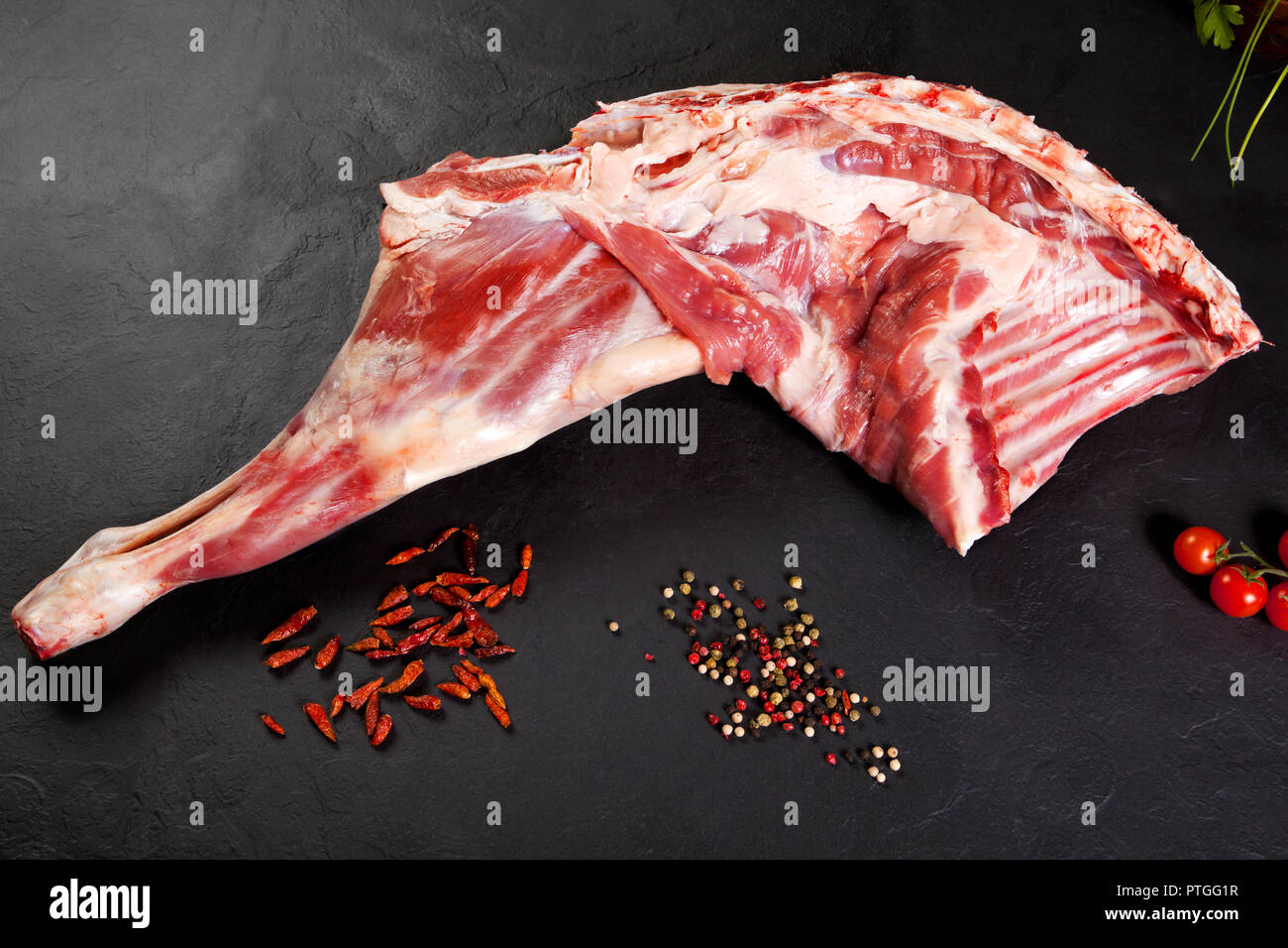 Raw lamb leg meat for cooking on grill and barbecue. Black background ...