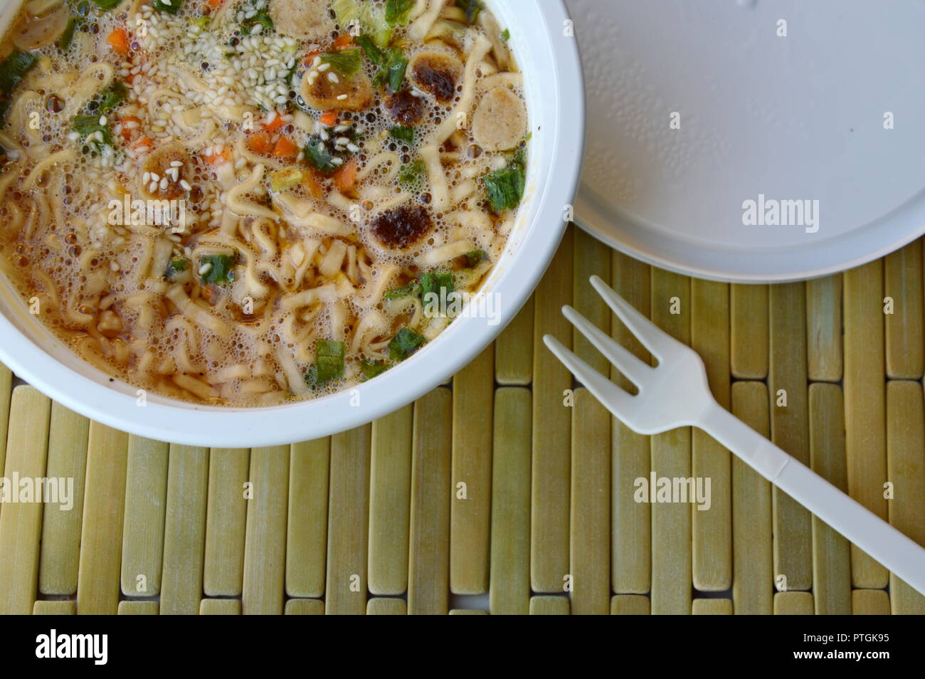 instant noodle soft boiled in plastic cup on bamboo plate Stock Photo ...