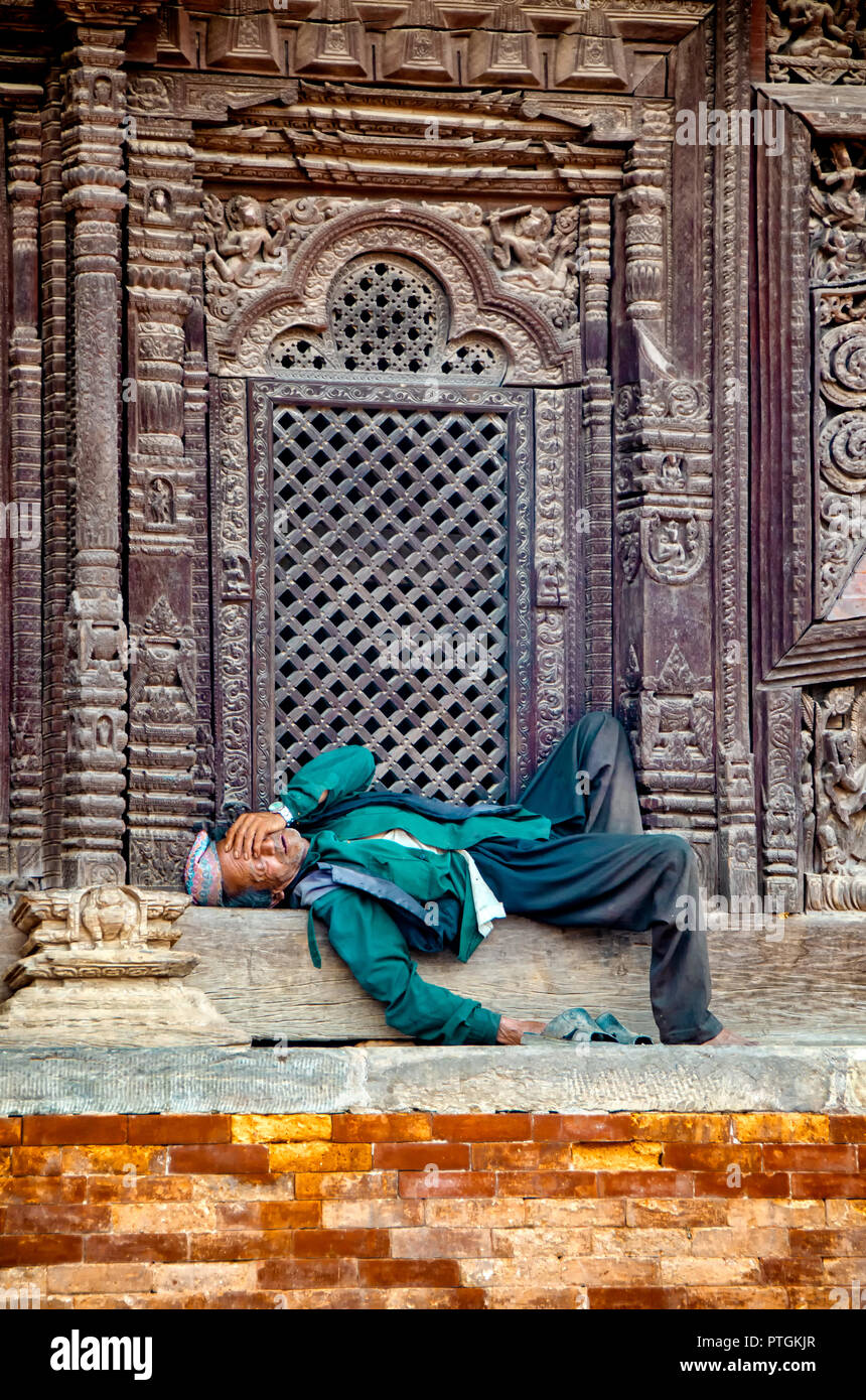 Nepalese Man in Traditional Dress Napping in an Intricate Temple ...