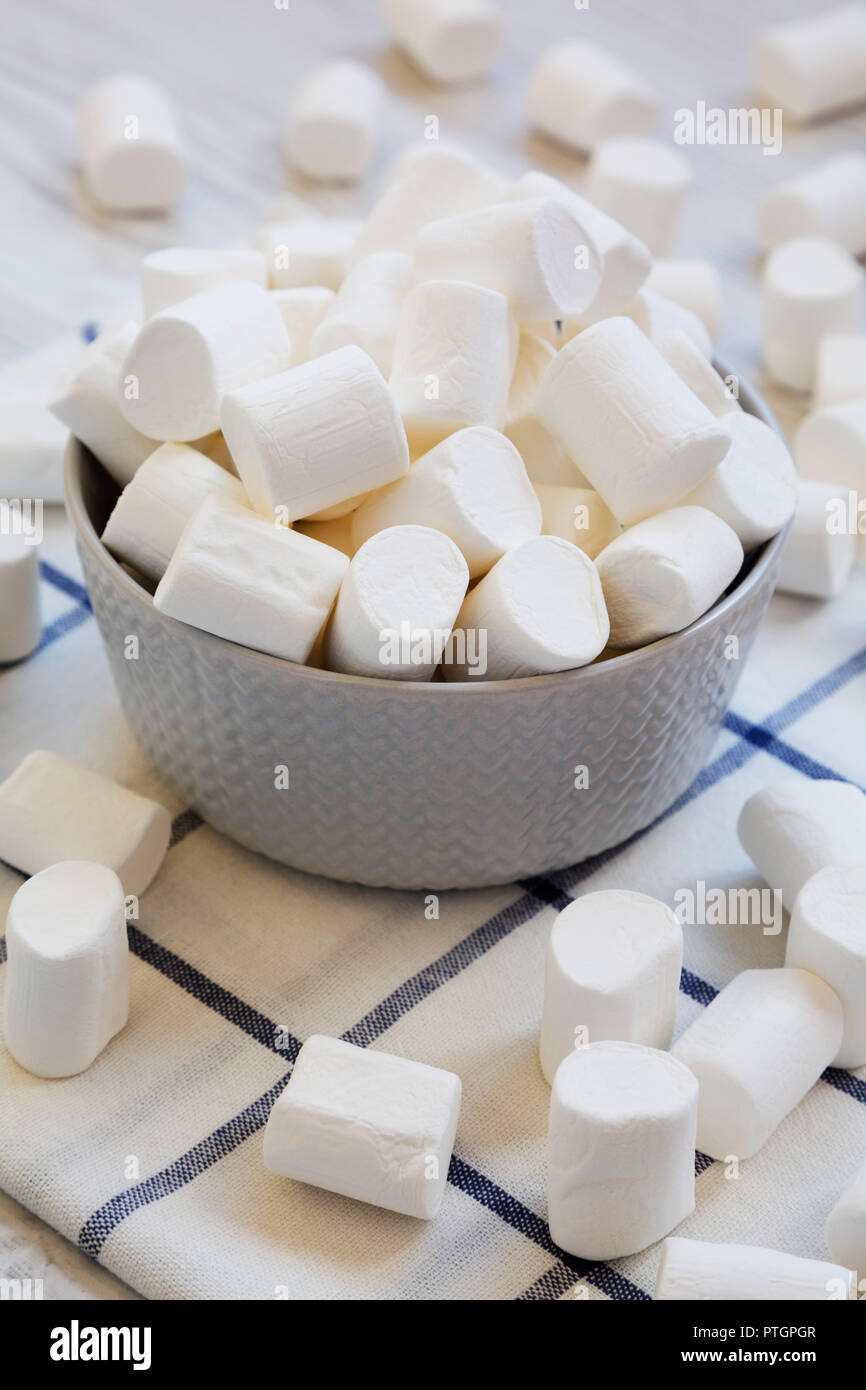 Sweet white marshmallows in a grey bowl, side view. Close-up Stock ...