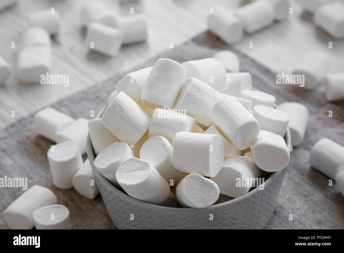 Sweet white marshmallows in a bowl, side view. Close-up Stock Photo - Alamy
