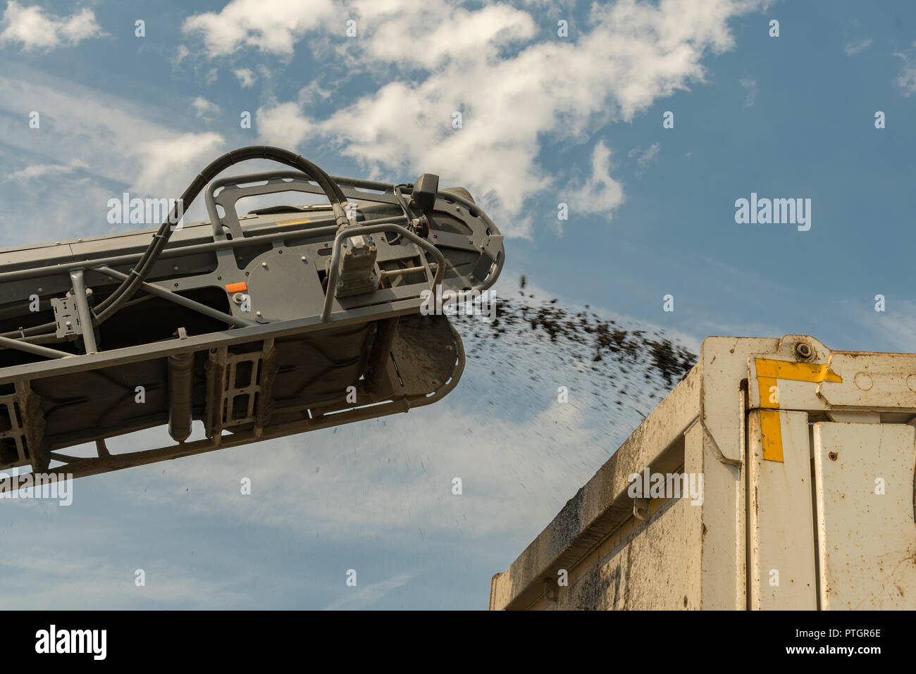 loading road debris in the car. A heavy tractor removes the old asphalt ...