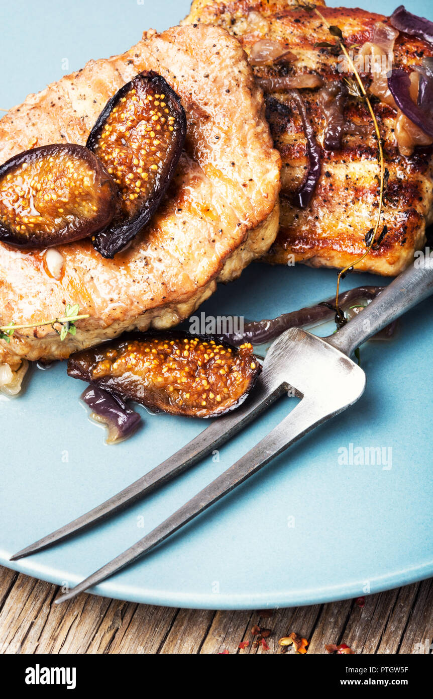 Baked meat with onion and figs on plate.Steak with figs sauce Stock ...