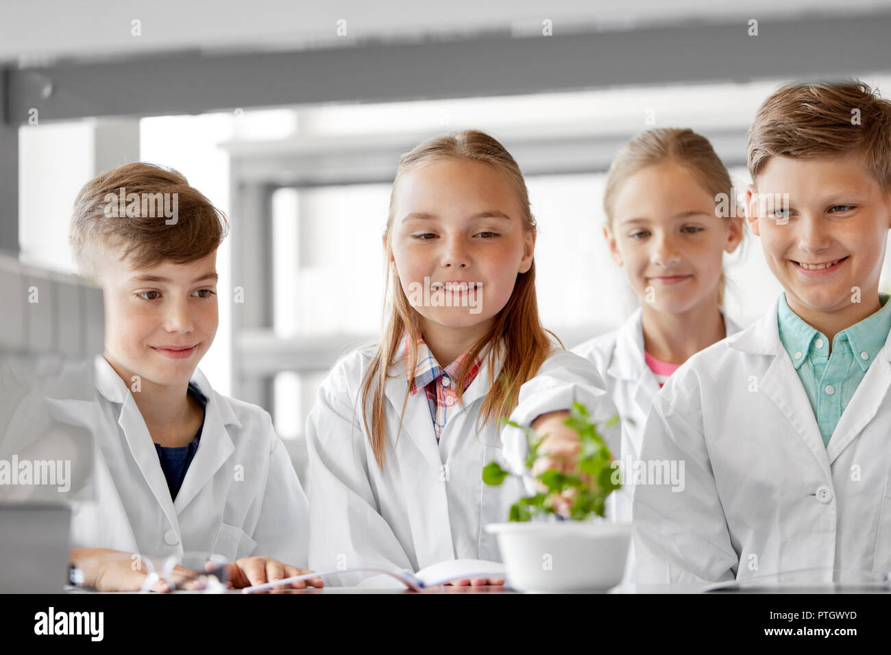 kids or students with plant at biology class Stock Photo - Alamy
