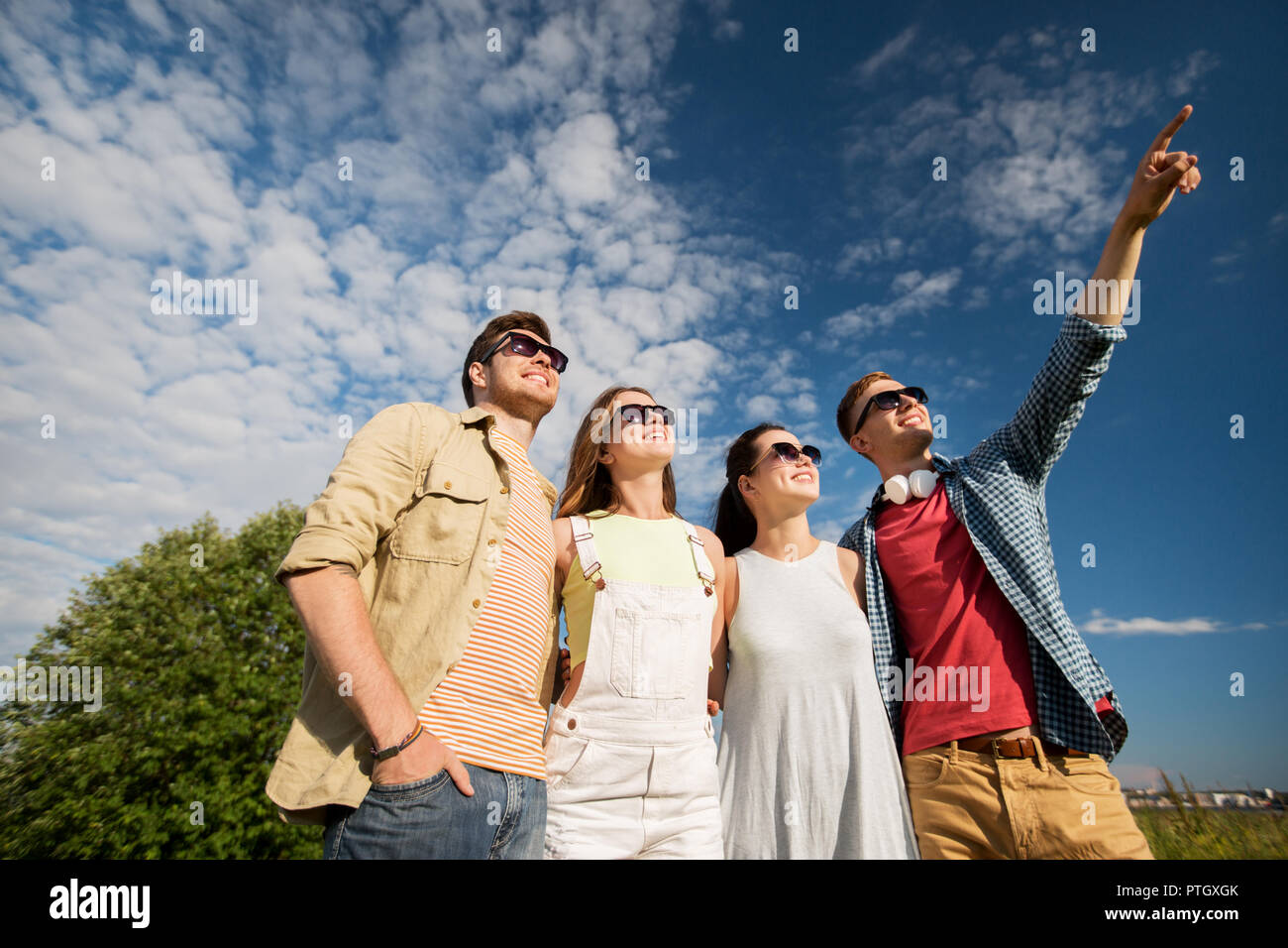 happy friends looking at something outdoors Stock Photo - Alamy