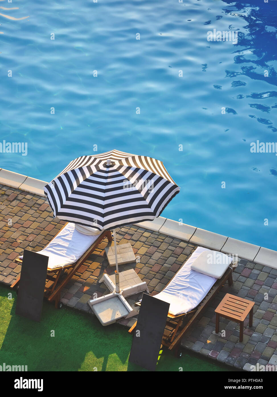 swimming pool with sun loungers Stock Photo - Alamy