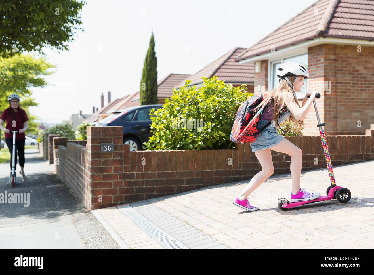 Girl riding a scooter hi-res stock photography and images - Alamy