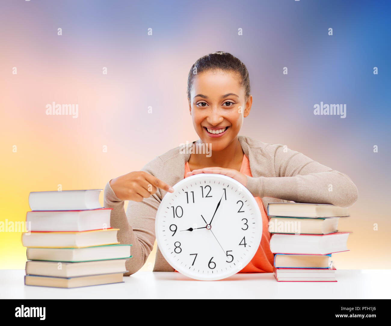 student girl with books showing time on clock Stock Photo - Alamy