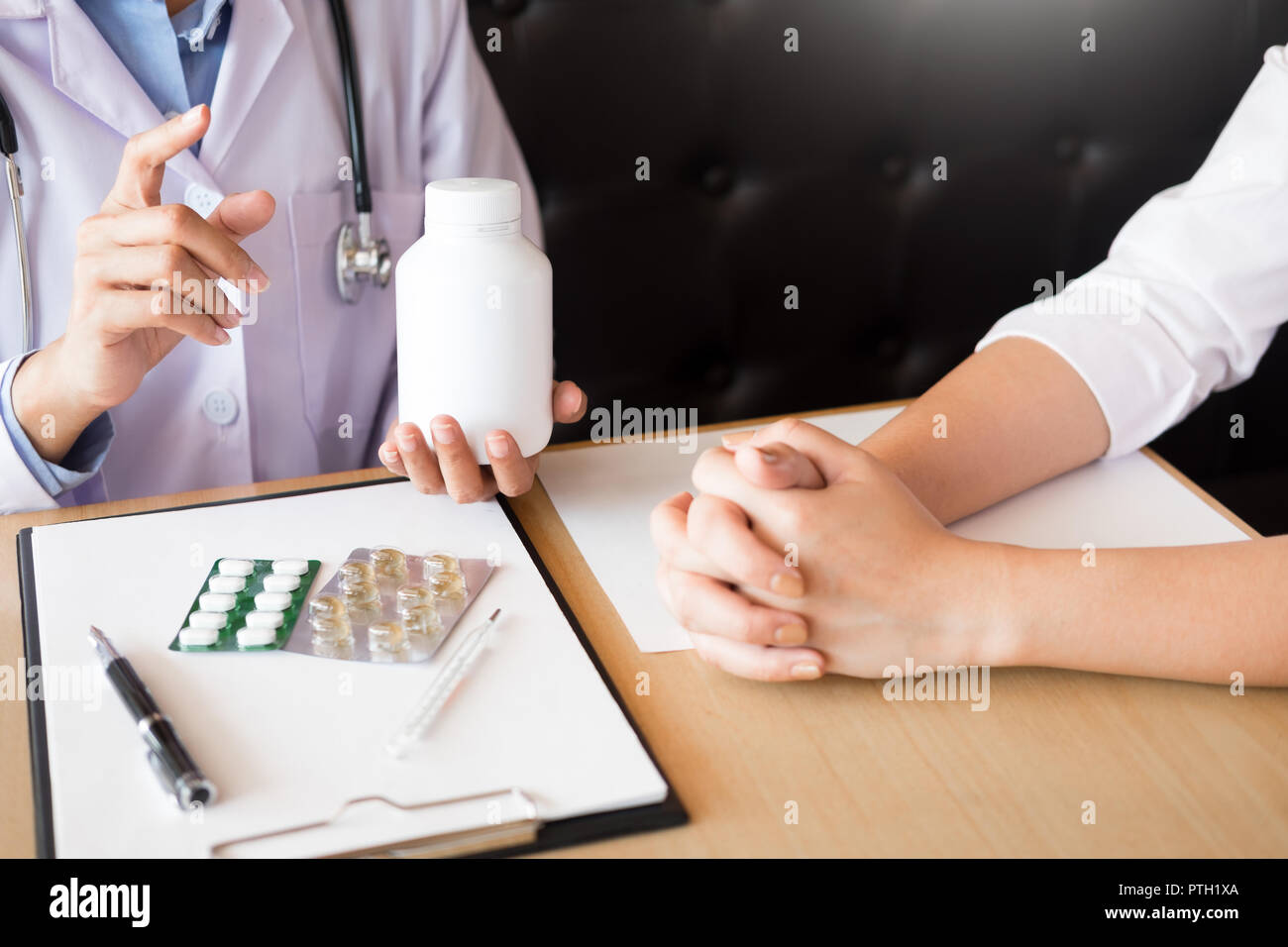 doctor hand holding tablet of drug and explain to patient in hospital ...
