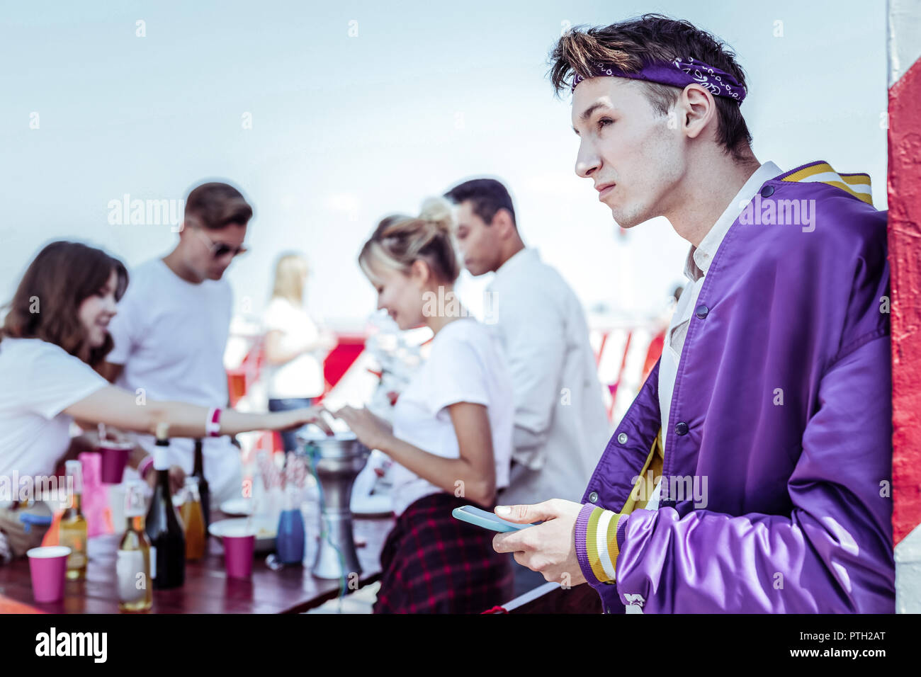 Thoughtful young man standing in semi position Stock Photo - Alamy