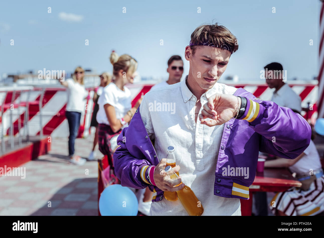Concentrated male person looking at his smart watches Stock Photo - Alamy