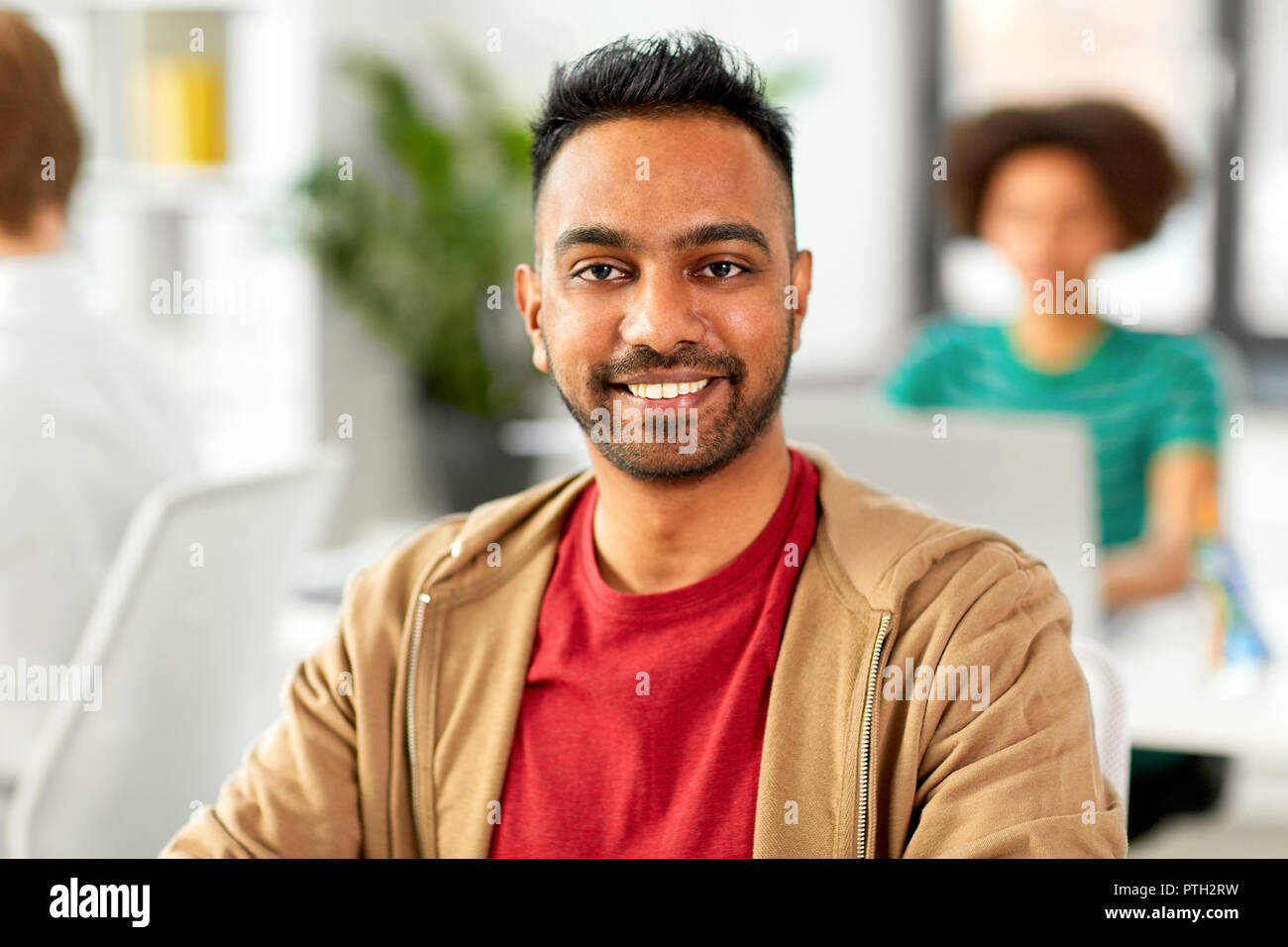 smiling indian man at office Stock Photo - Alamy