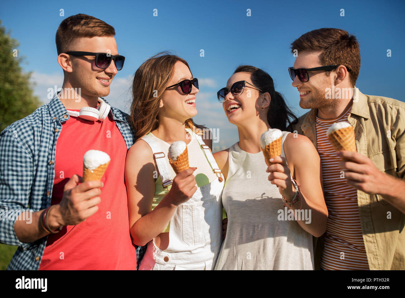 group of smiling friends with ice cream outdoors Stock Photo - Alamy