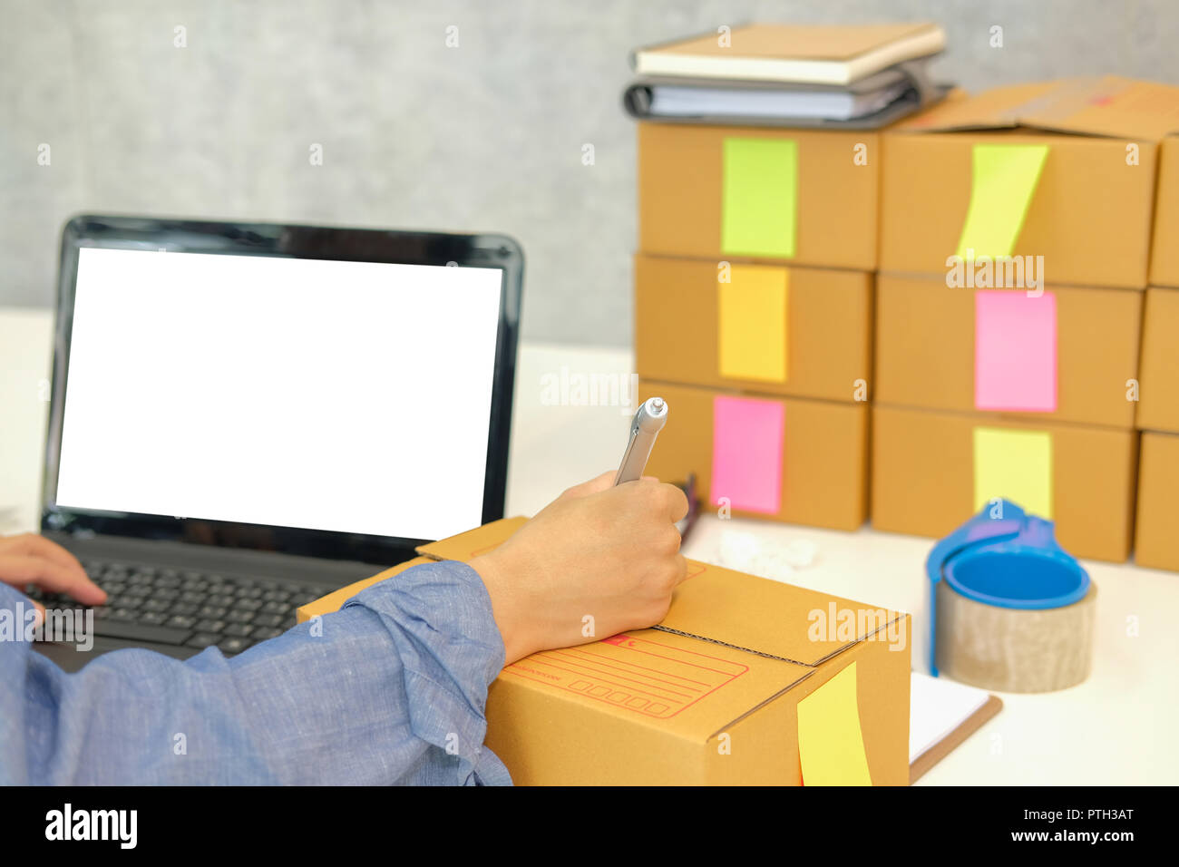 startup small business owner writing address on cardboard box at ...