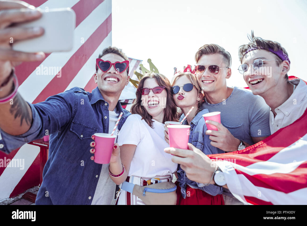 Emotional people looking at telephone of their friend Stock Photo - Alamy