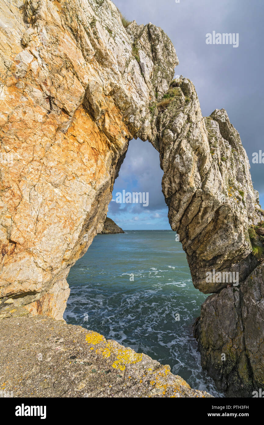 Natural rock arch at the abandoned Porth Wen Brickworks Porth Wen Bay ...