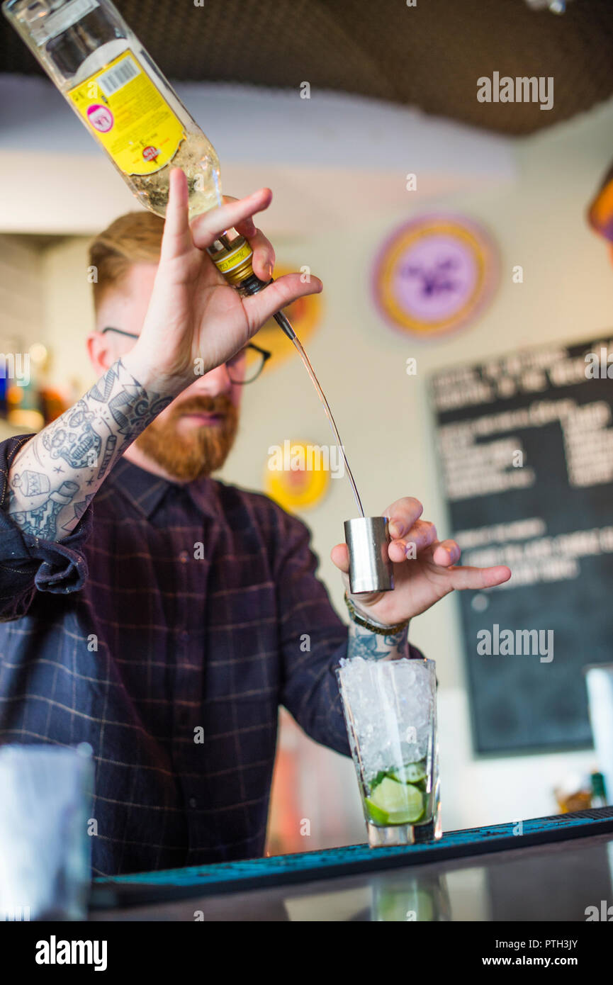 A barman pouring cocktails at the Baravin Restaurant and cafe bar ...