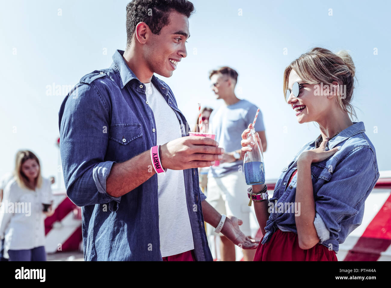 Surprised female looking at her new group mate Stock Photo - Alamy