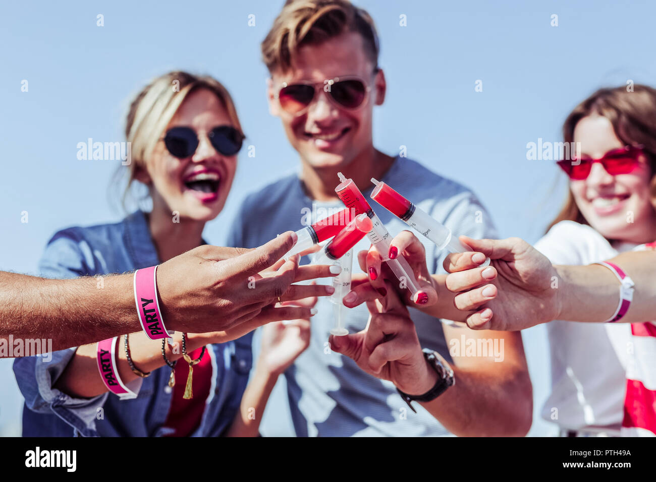 Positive delighted male person standing between girls Stock Photo - Alamy