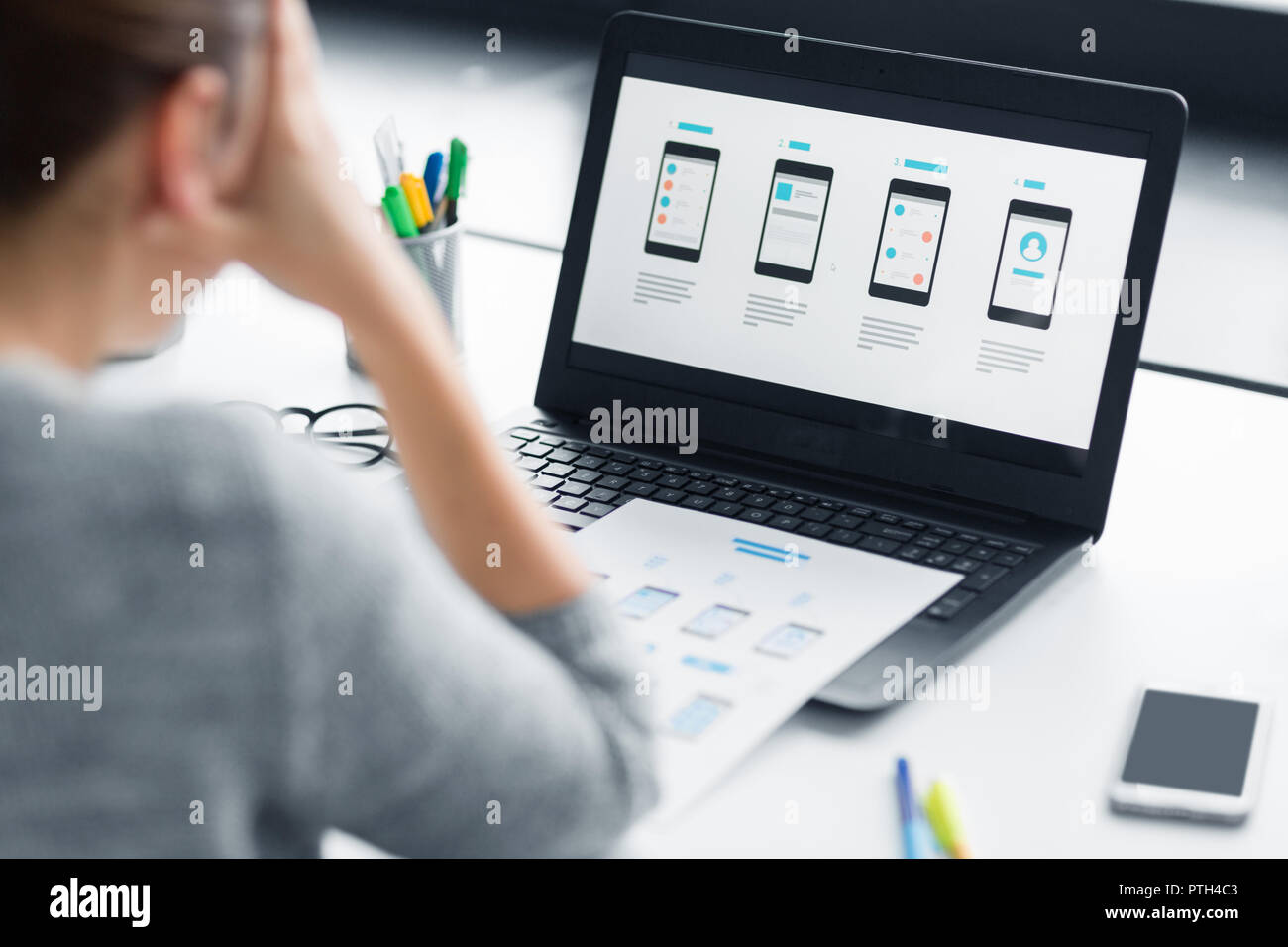 stressed designer with user interface on laptop Stock Photo - Alamy
