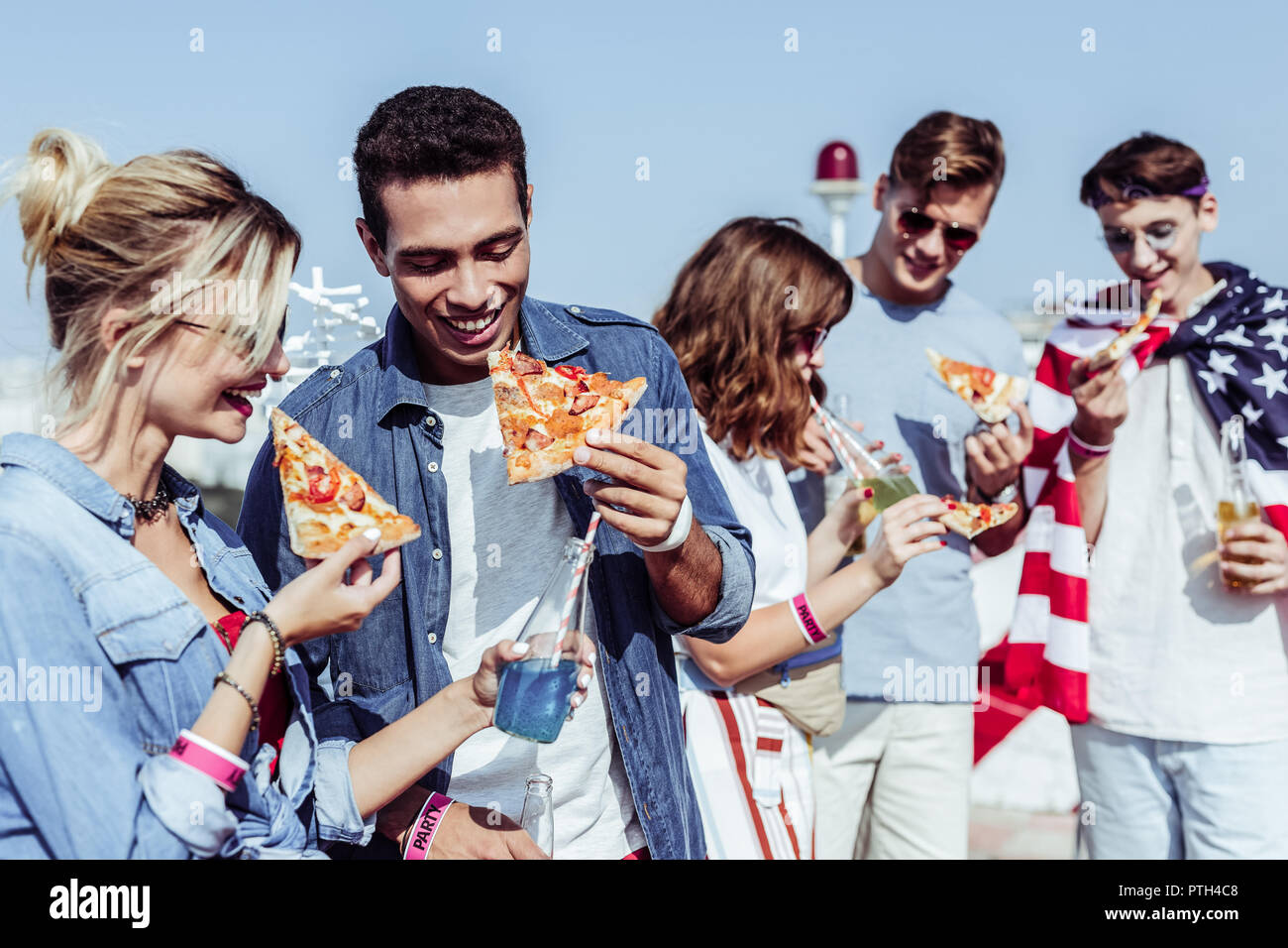 Hungry students eating tasty pizza with beer Stock Photo - Alamy