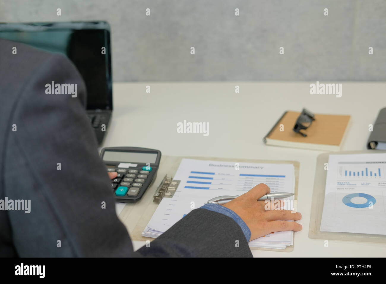 financial adviser working with calculator at office. accountant doing ...