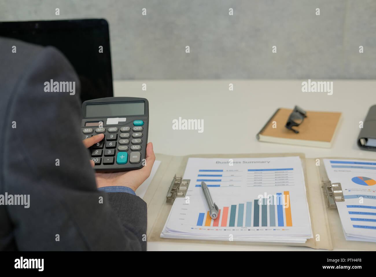 financial adviser working with calculator at office. accountant doing ...