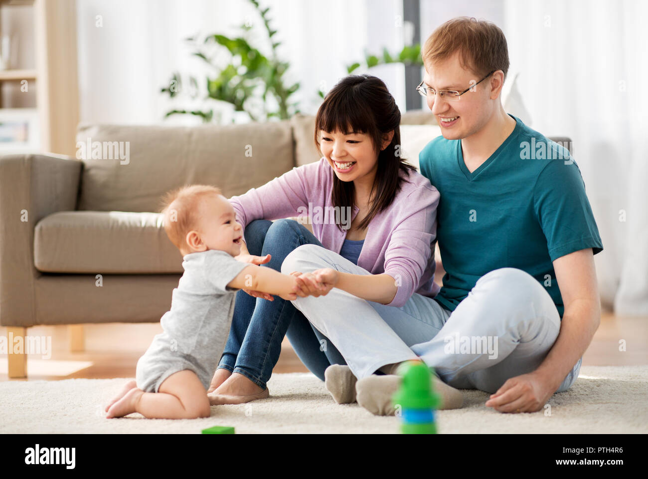happy family with baby boy at home Stock Photo - Alamy