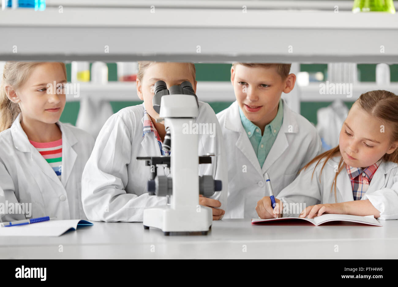 kids or students with microscope biology at school Stock Photo - Alamy