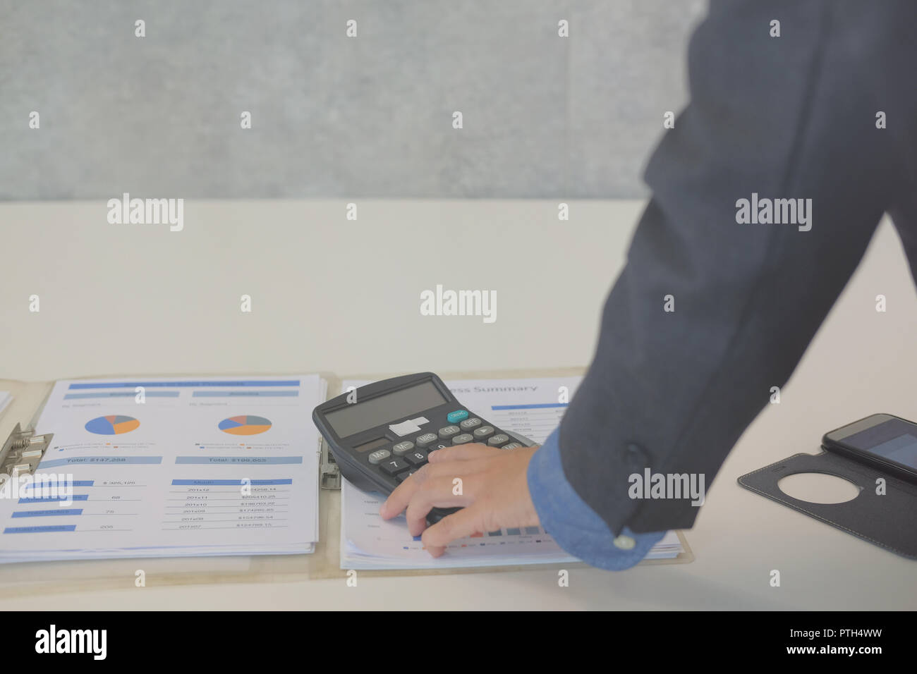 financial adviser working with calculator at office. accountant doing ...